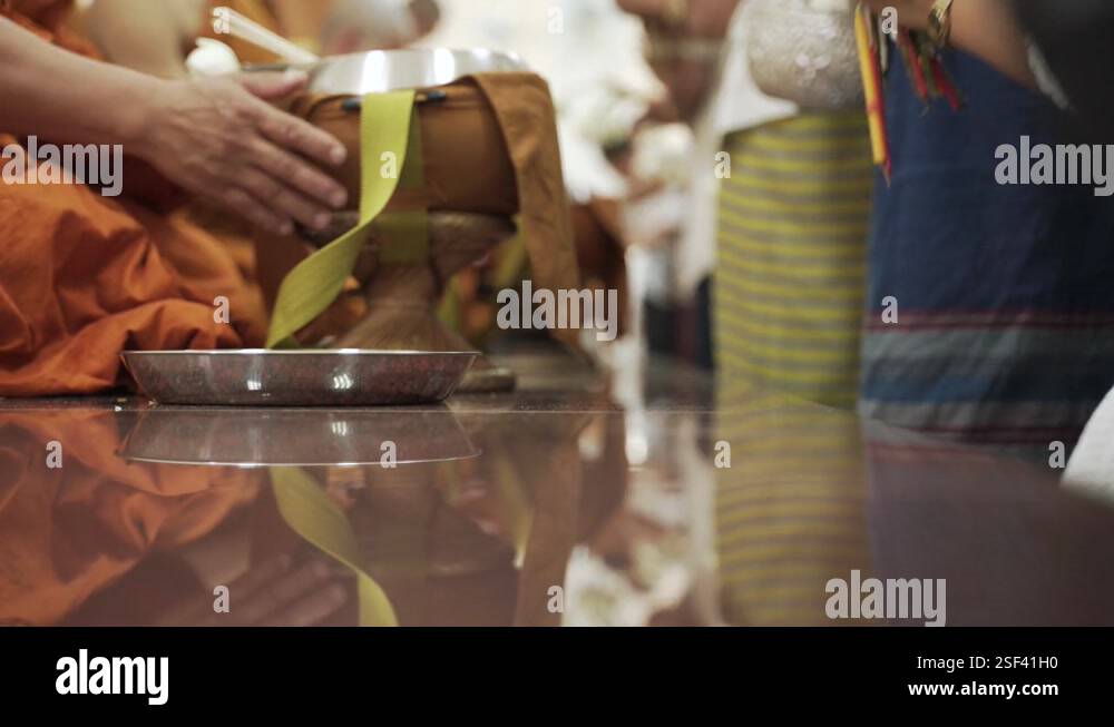 Thai people give alms to new ordained monk Stock Video Footage - Alamy