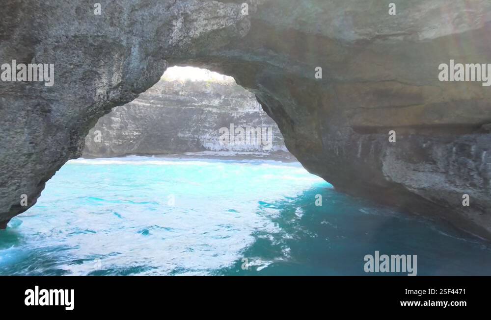 Flying through the tunnel under the stone-arch at Broken Beach, Nusa ...