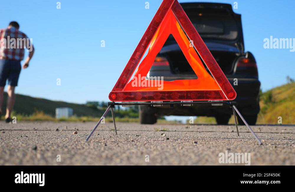 Close up of red emergency stop sign standing on road. Worried and angry ...