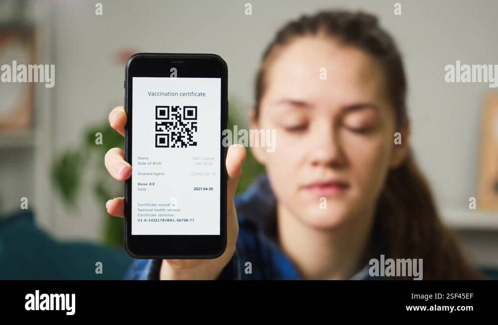 Woman showing on phone vaccination passport with qr code, international ...