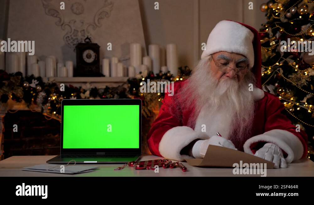 Santa Claus writes congratulations children on New Year, laptop green ...