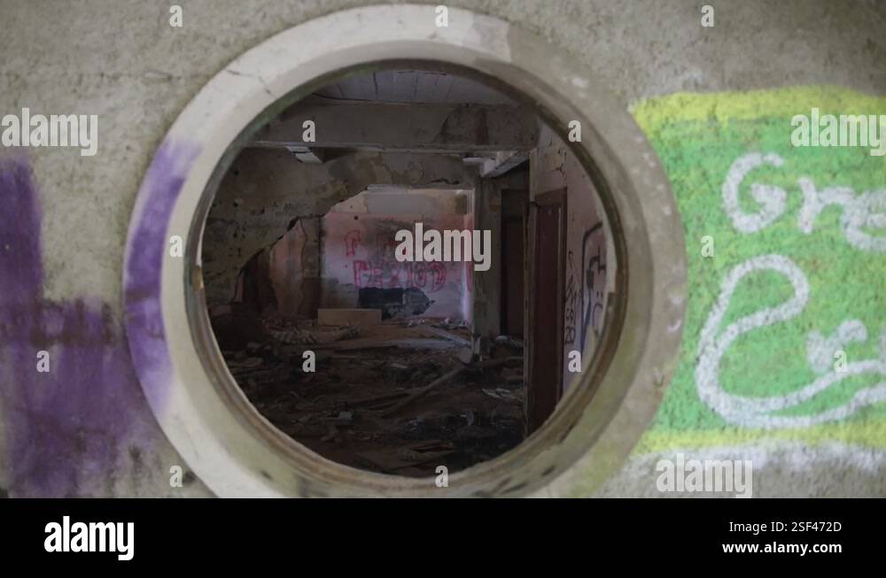 Camera passing through a circular hole. Suspenseful handheld dolly shot ...