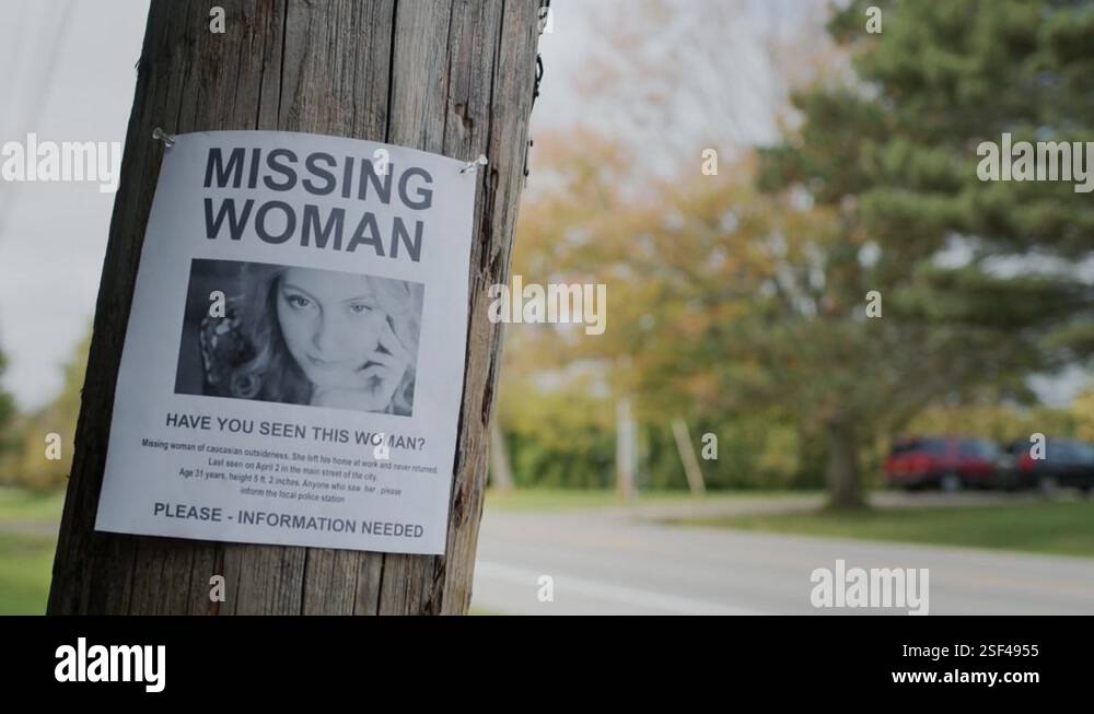 An advertisement for a missing young woman hangs on a pole near the ...