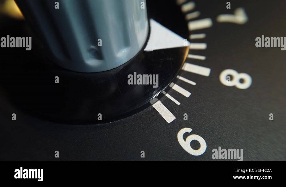 Detail shot. Rotating the variable resistor knob on old equipment on a ...