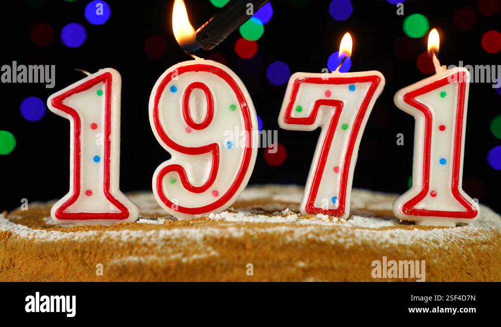 Birthday cake with white burning candles in the form of number 1971 ...