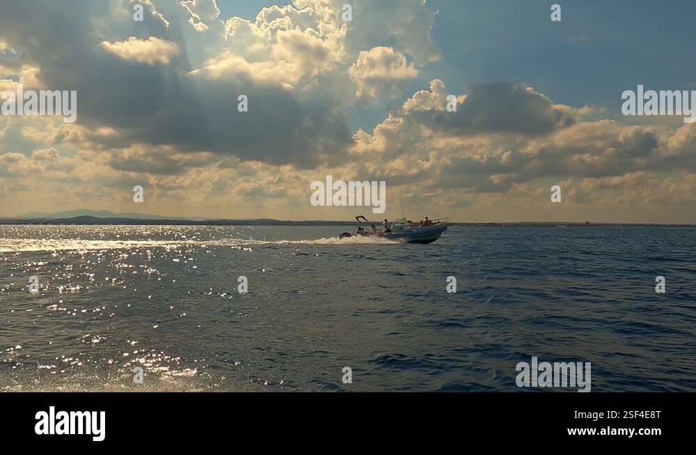 Low-angle sea-level view of motorboat running on sea water as seen from ...