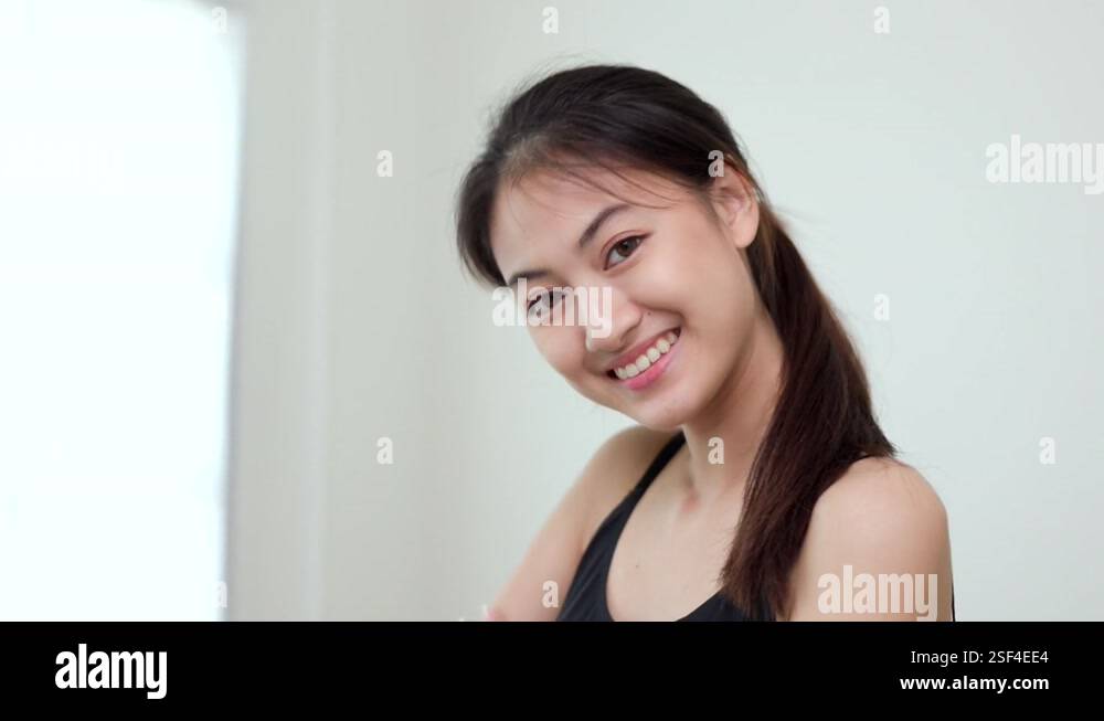 Young beautiful asian woman standing pose smiling to camera. Cheerfully ...