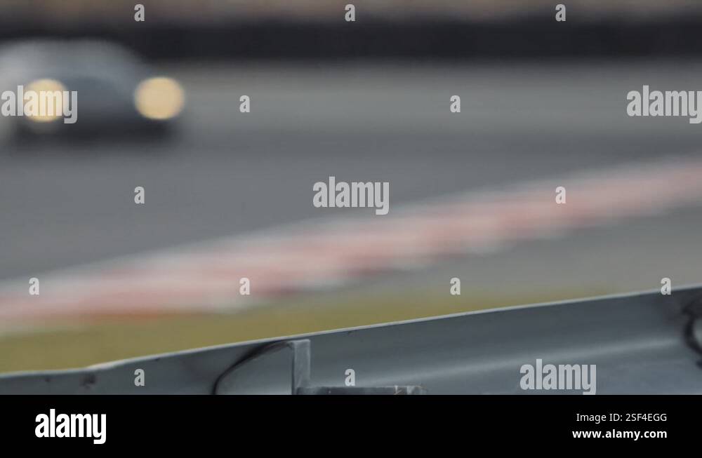 Racing cars driving past camera out of focus with focus rack Stock ...