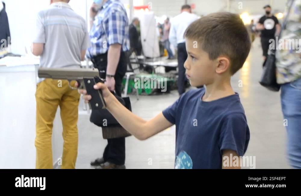 Child shoots weapon in digital dash. Airguns gun. Boy shoots weapon ...