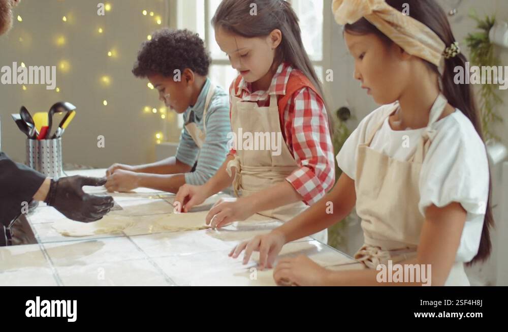 Baker Giving Cooking Masterclass to Kids Stock Video Footage - Alamy