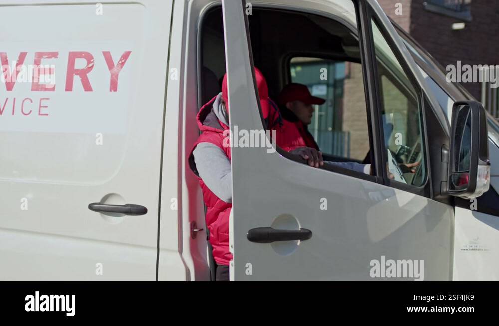Couriers delivering parcel box to recipient. African american delivery ...