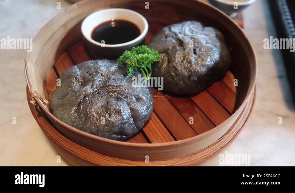 Black BBQ Bao Buns with Soy Sauce inside Bamboo Steamer Dimsum Chinese ...
