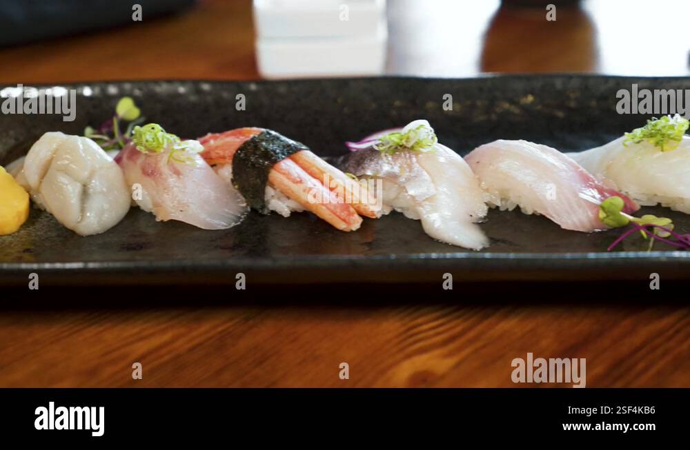 Colorful unique line of traditional nigiri on elegant sushi platter ...