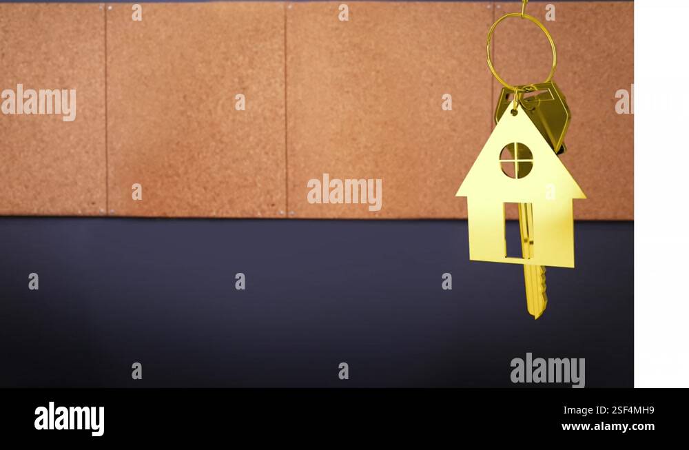 Animation of gold key with key fob over brown and black background ...