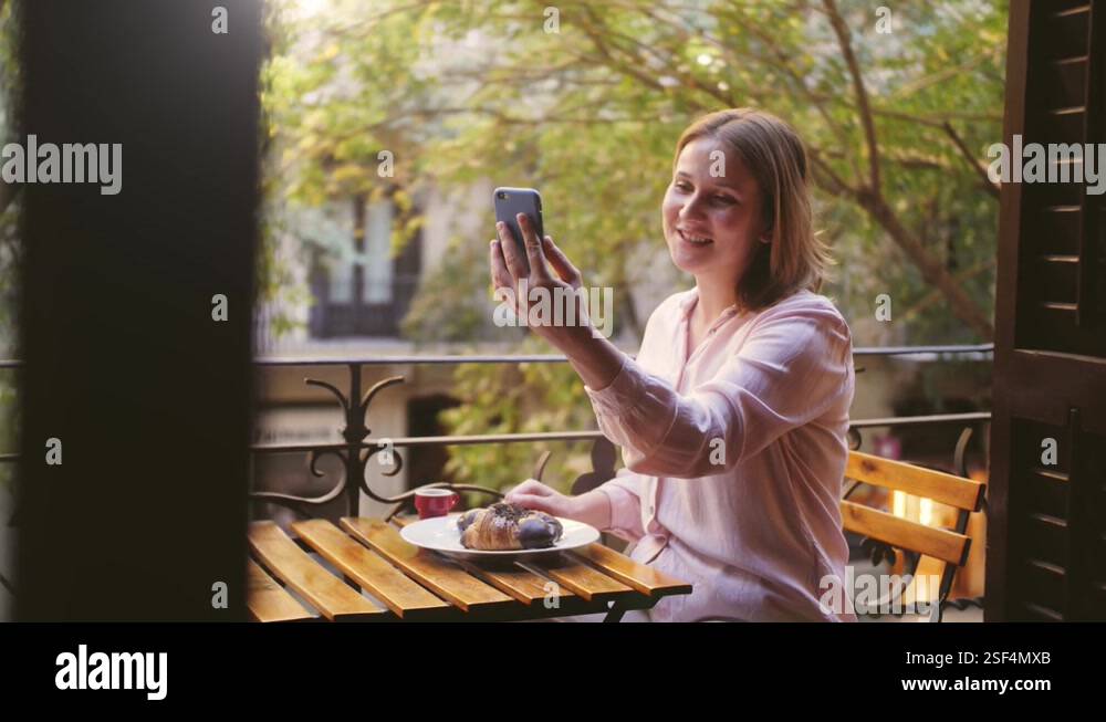 Happy young woman making facetime video chat calling with smartphone at ...