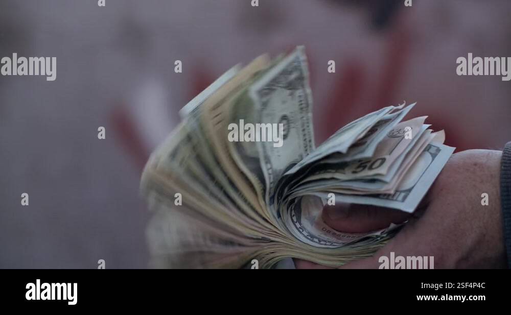 Slow motion close-up of a person flapping around a handful of prop ...