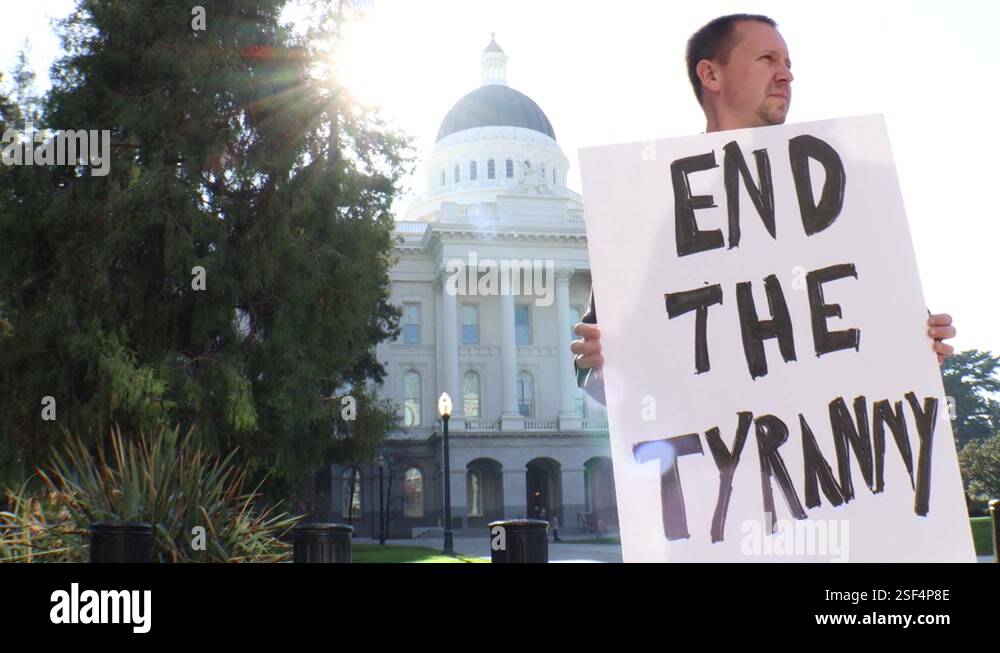 Male Political Protester with End the Tyranny Sign Slider Dolly ...