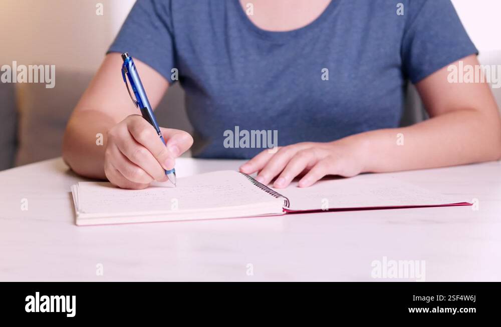 Close Up hands taking notes on a notebook about accounting of every ...
