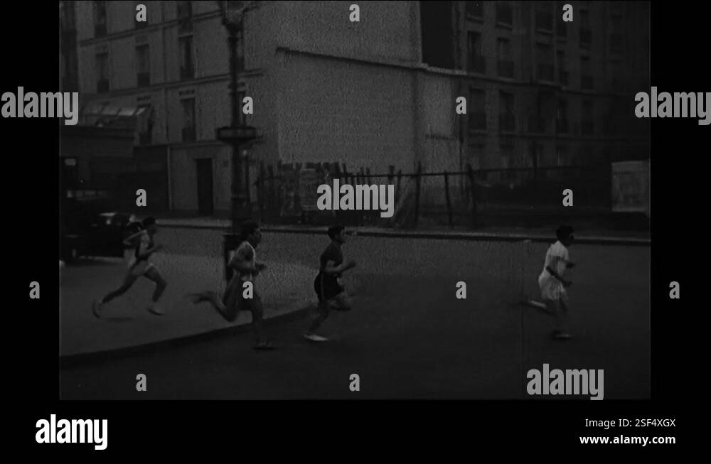 1930s: Racers run down a sidewalk. Running up stairs. Runner holds a ...