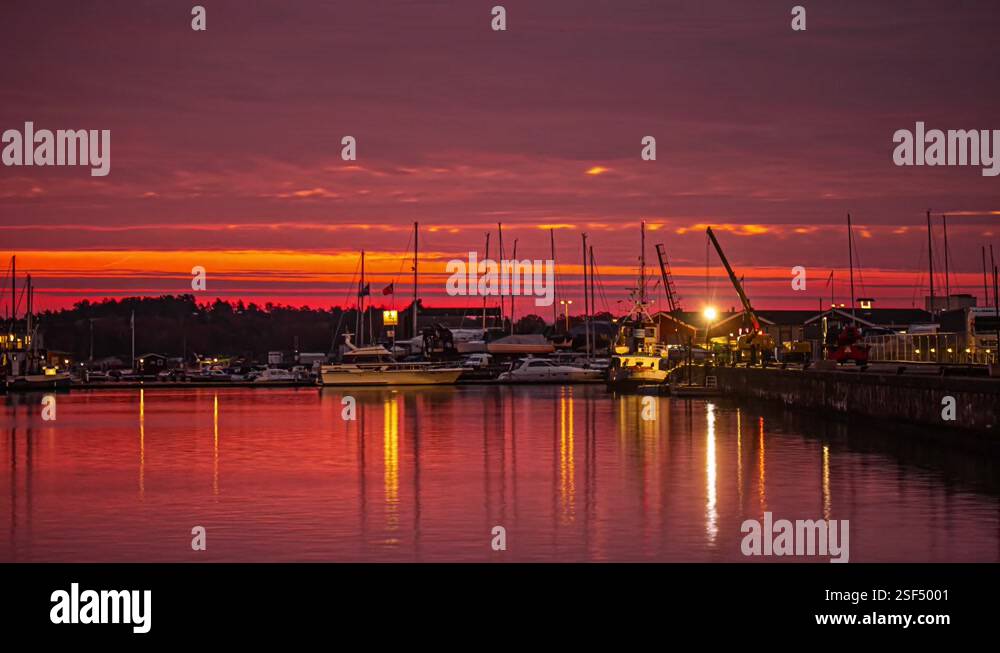 Night to sunrise timelapse of work going on under halogen light at a ...
