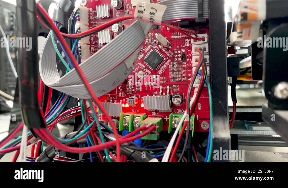 Close up of red circuit board with chips transistors, white markings ...