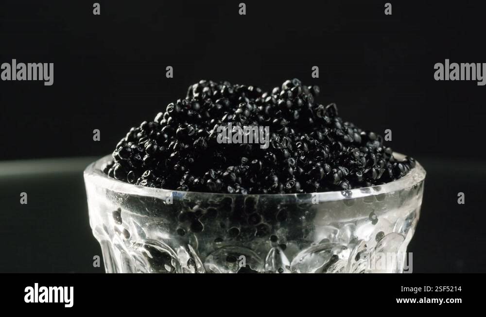 Black caviar close-up. Beluga sturgeon salted roe in glass bowl. Raw ...