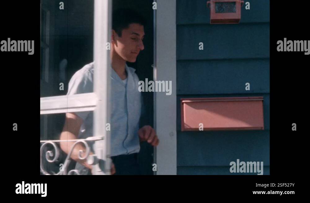 1960s: Man opening door, checking mailbox. Man browsing envelopes ...