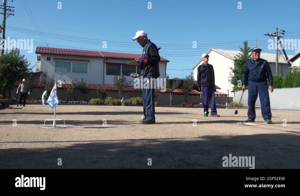Japanese elderly play a game of 'gateball', excercise, aged, senior ...