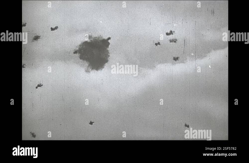 1940s: Anti-aircraft guns firing. Shells and planes exploding in the ...