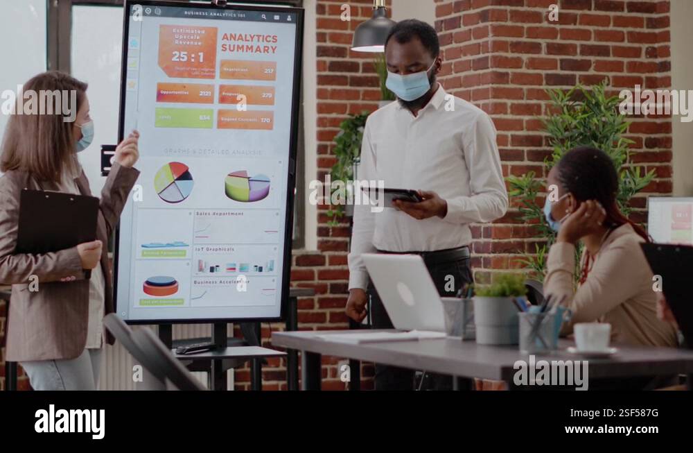 Team of diverse workmates presenting business strategy on display Stock ...