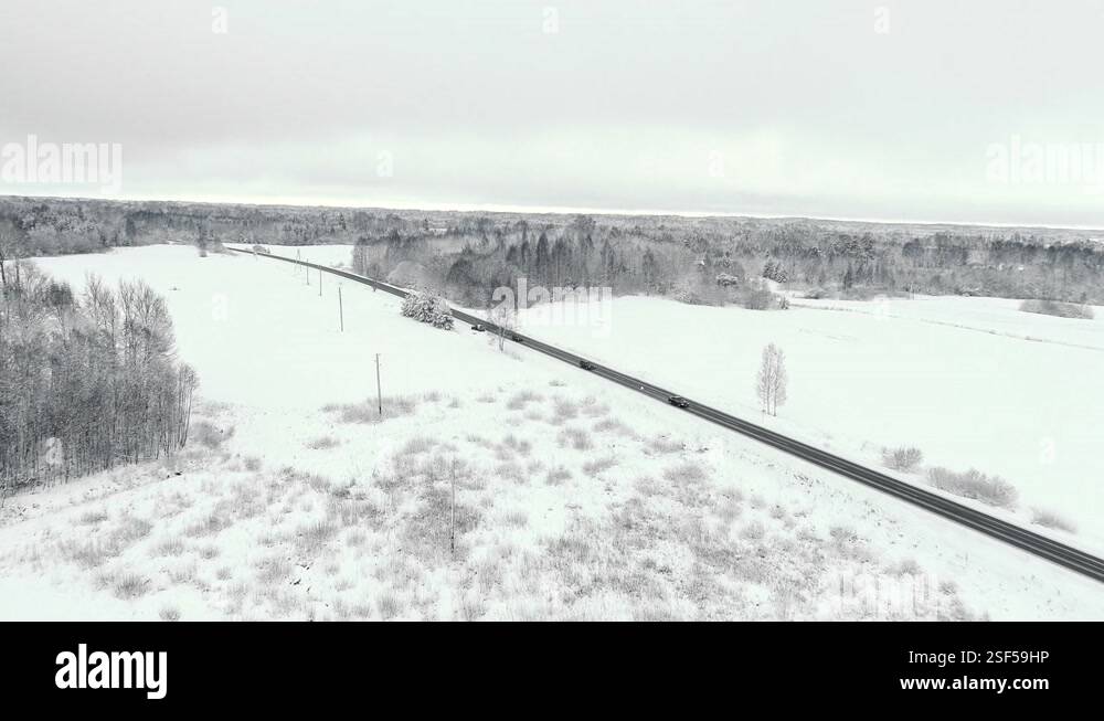 Cars Crossing a remote Country Road through wild Frozen Field and ...