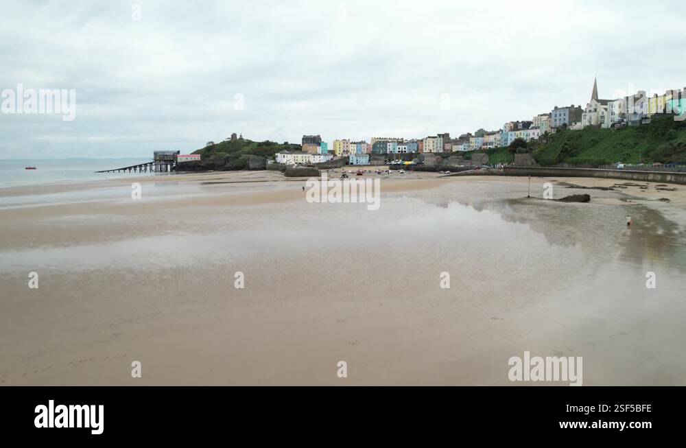 Shallow water on beach at low tide buildings in town Stock Video ...