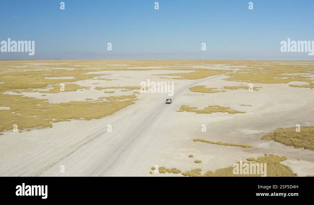 Car Driving On Desolate Desert Of Kubu Island With Salt Pan On Sunny ...