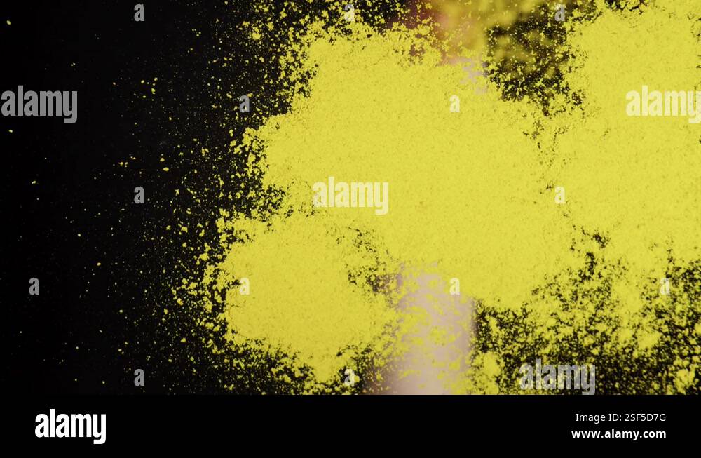 Pouring turmeric powder on glass on black background, using seasoning ...
