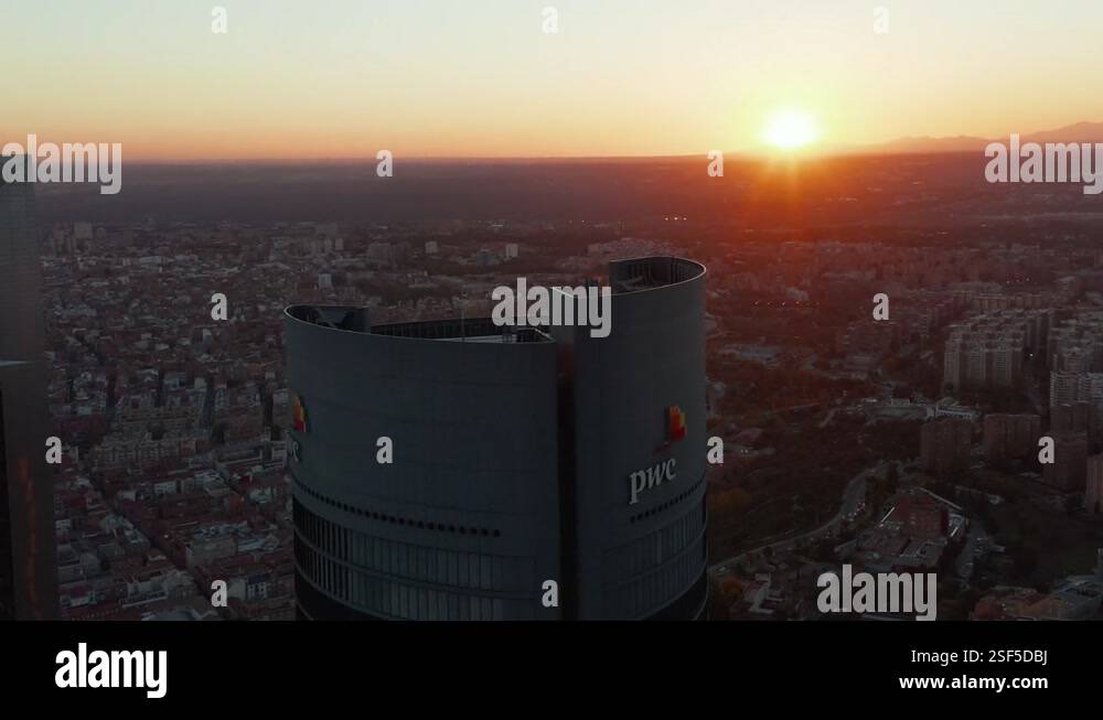 Fly around top of PWC tower in Cuatro Torres Business area. Modern high ...