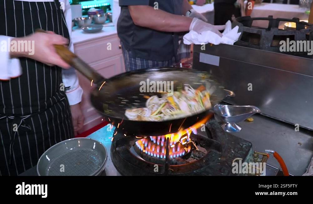 Chef Hand Wok Tossing An Asian Cuisine of Mixed Seafood and Vegetables ...
