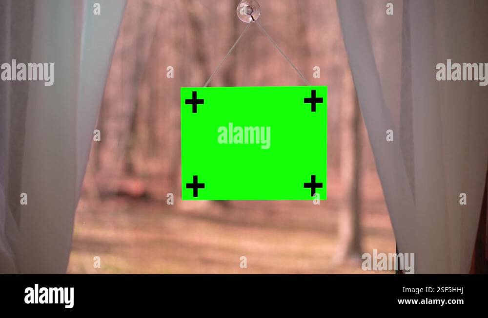 Push into blank green screen chroma key sign hanging in a store window ...