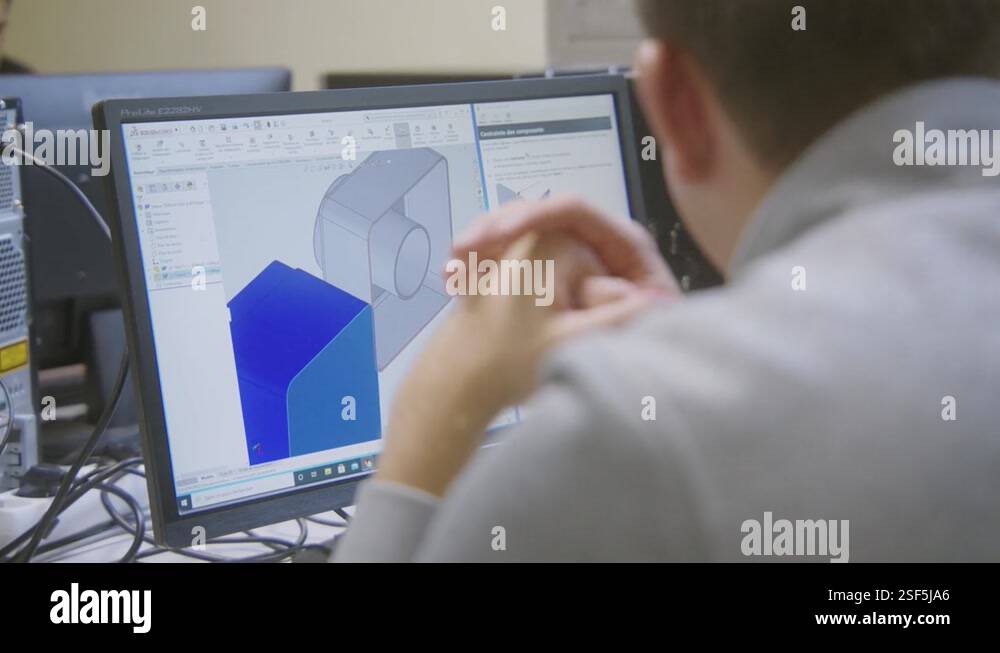 Students working on computers and tablets in a french international ...