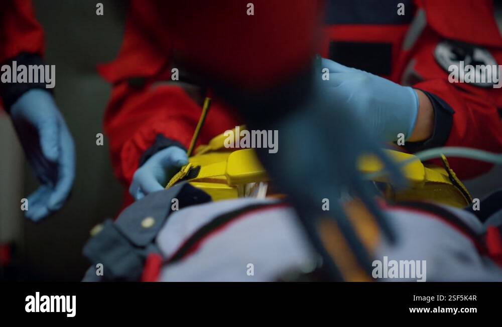 Team of paramedics providing first aid help for injured patient in ...