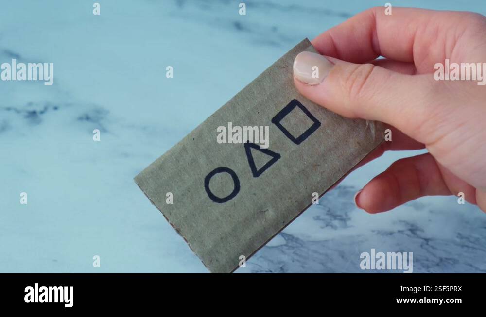 Kiev Ukraine - October 2021 Hand holding a squid game invitation card ...