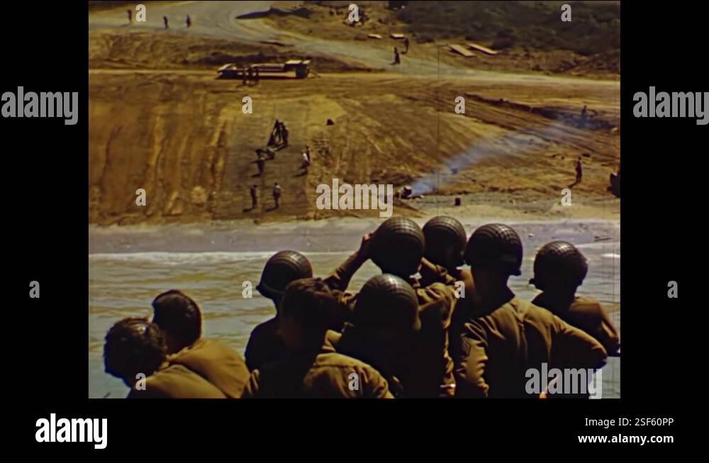 1940s: soldiers landing on beach and wading through water to get to ...