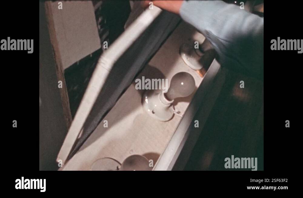 1940s: Hands screw light bulb into box, lights come on, zoom out to ...