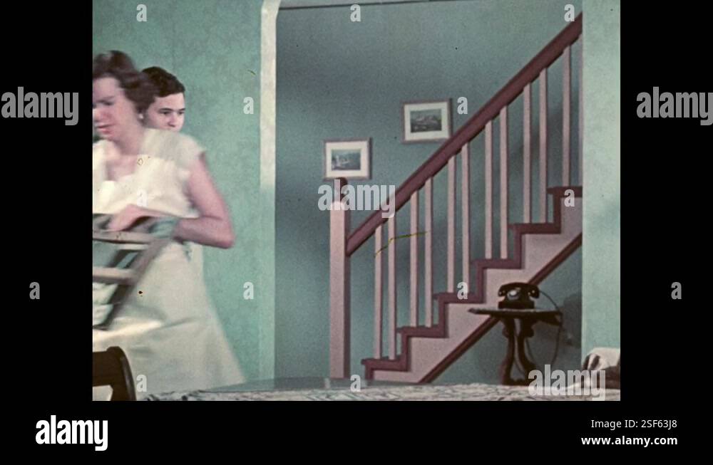 1950s: Film slate. Boy standing in dining room, apprehensively walks ...