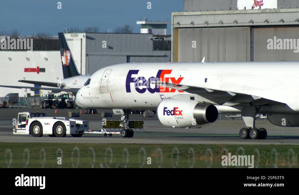 A Fedex Cargo Boeing 757 Being Towed by a Tow Truck, Vancouver Airport ...