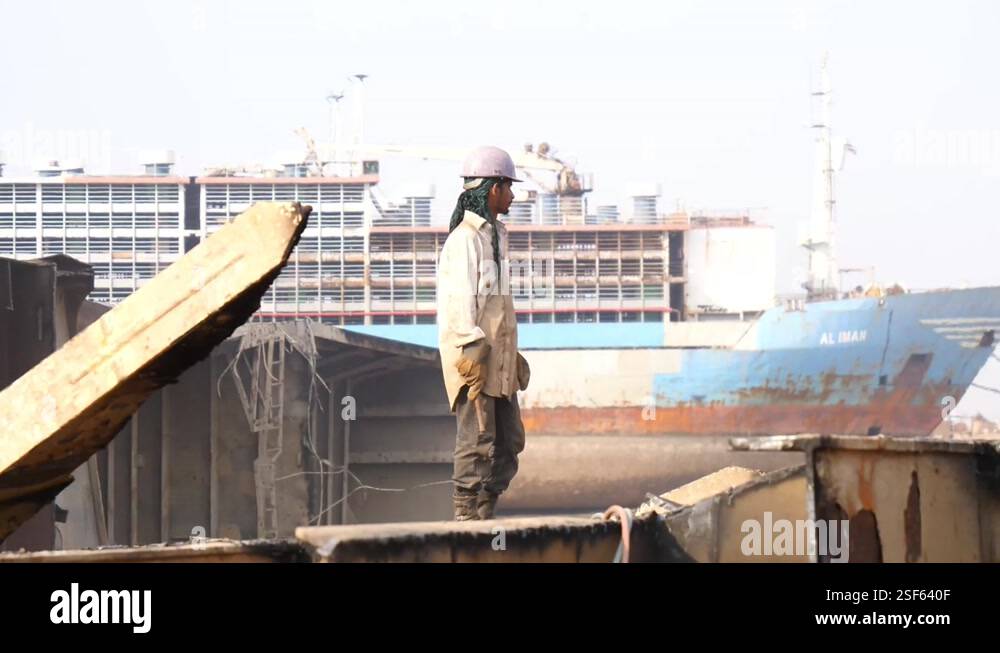 Worker Wearing Helmet Standing On Ship Hull At Breakers Yard In Gadani ...
