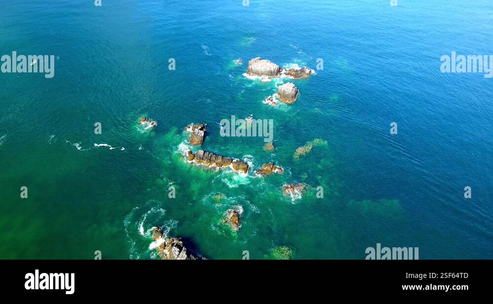 Overhead Flight for Rocks, Reefs and Waves Crashing in Clear Blue Water ...