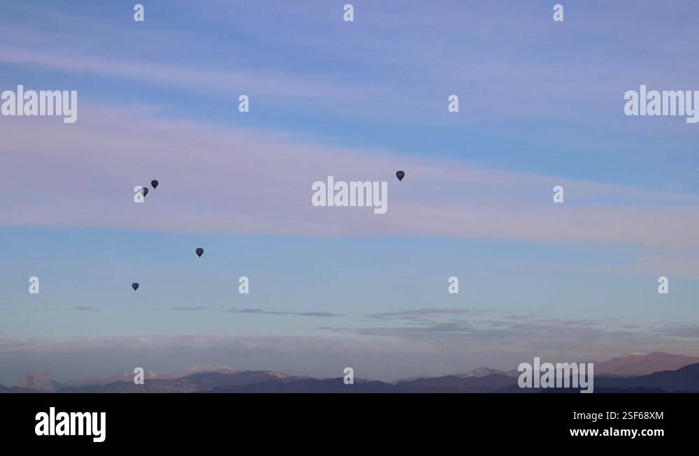 Timelapse. Hot-air balloon passing by from right to left under a blue ...