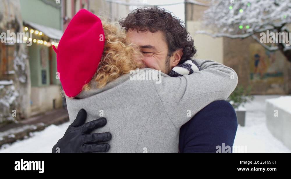 Beautiful couple meet each other on decorated street. Young man smiling ...
