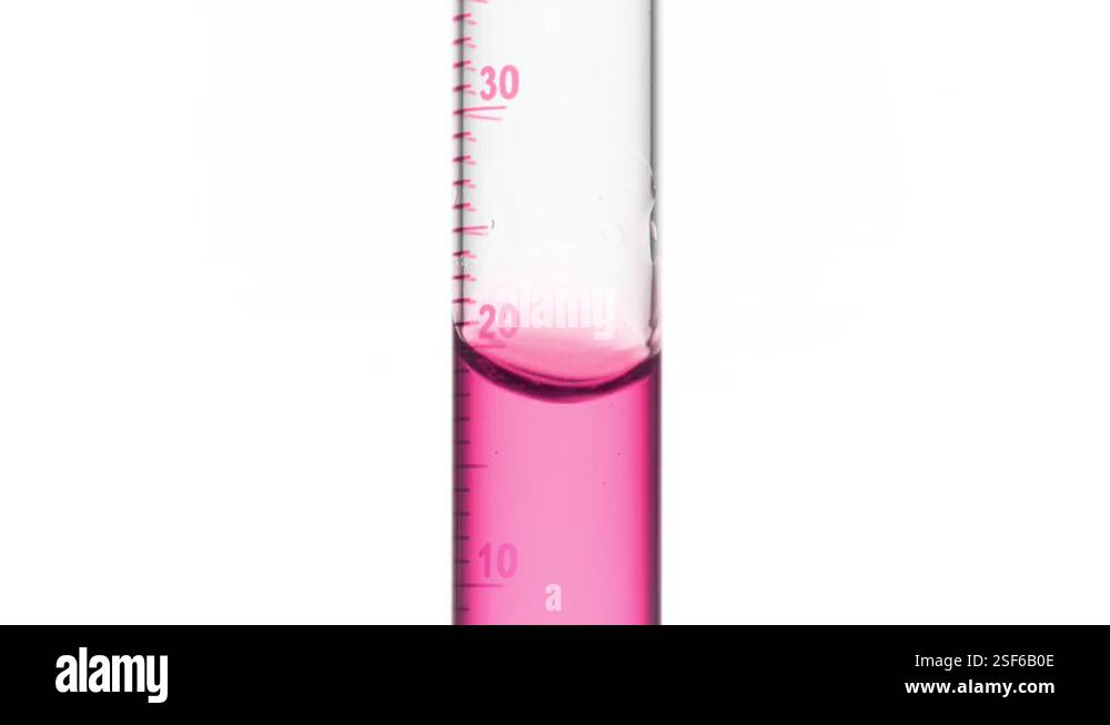 Drop of pink fluid is falling down into graduated cylinder Stock Video ...
