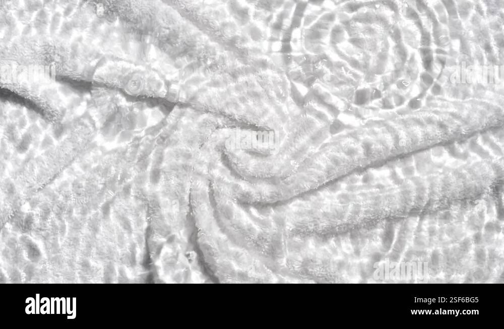 Drops falling in water making rings over white terry towel bg Stock ...